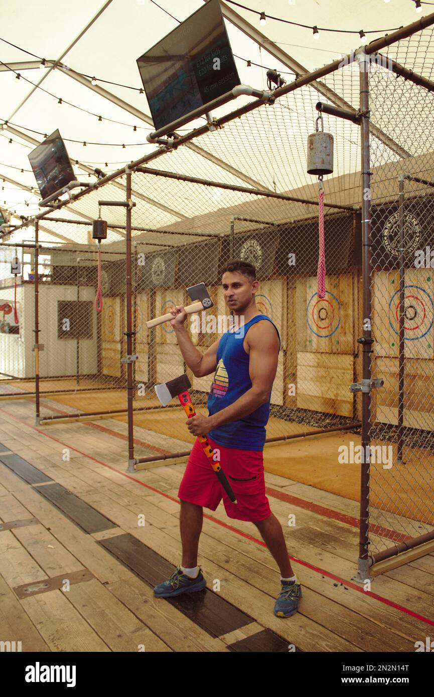 Axe throwing man Stock Photo - Alamy