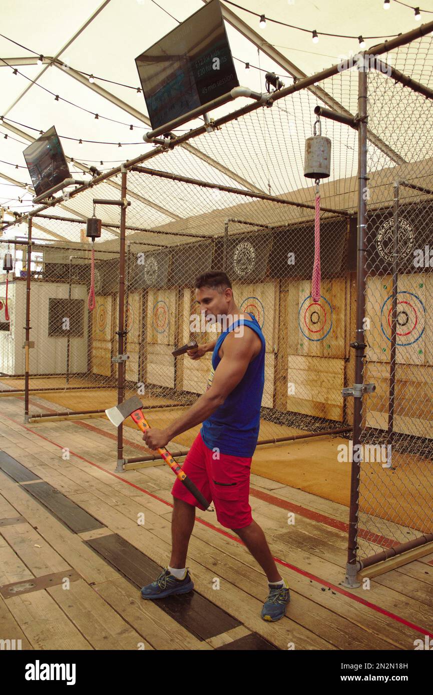 Axe throwing man Stock Photo - Alamy