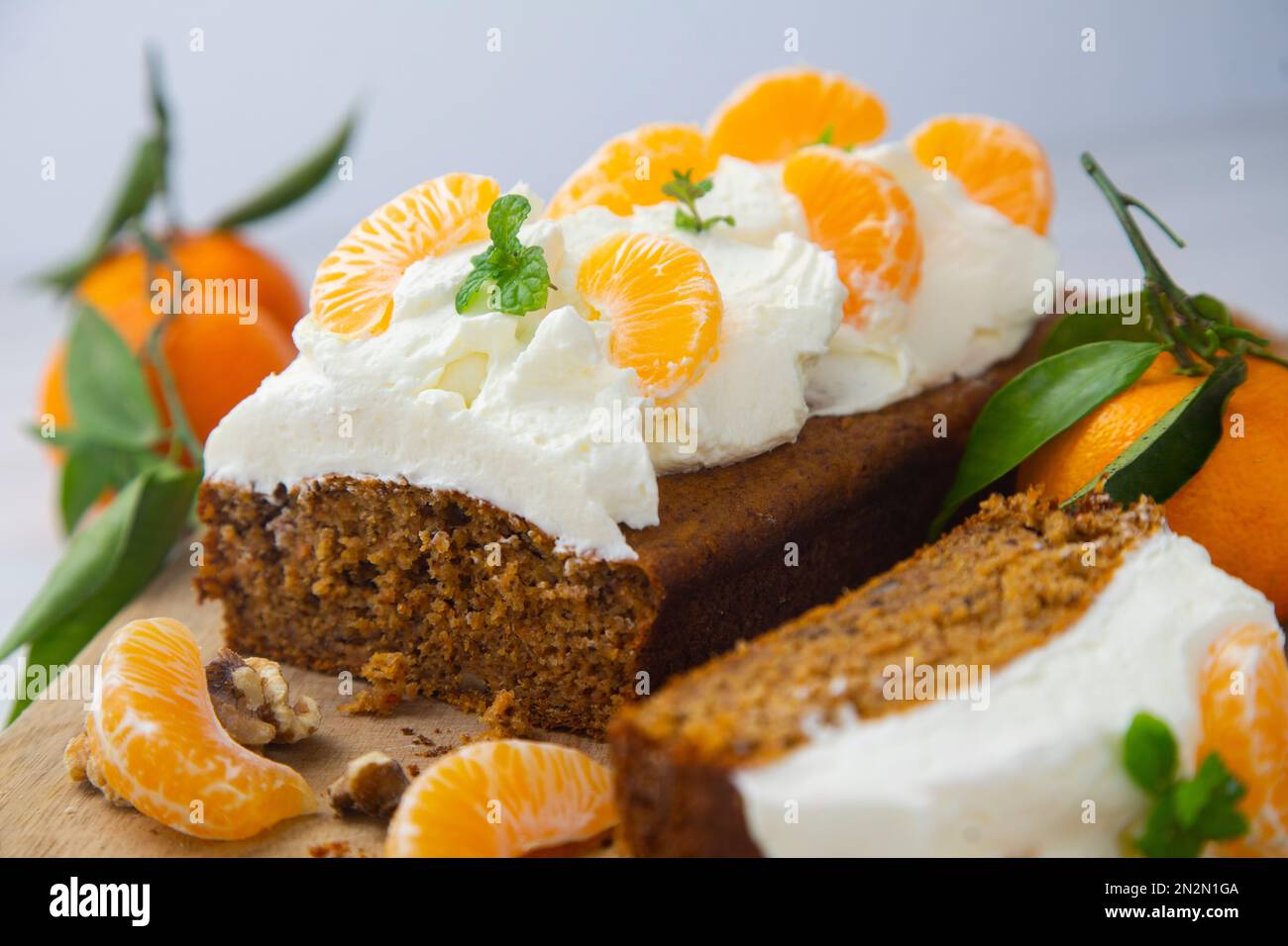 Carrot cake with cream frosting and tangerine pieces Stock Photo - Alamy