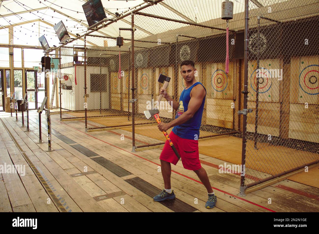 Axe throwing man Stock Photo - Alamy