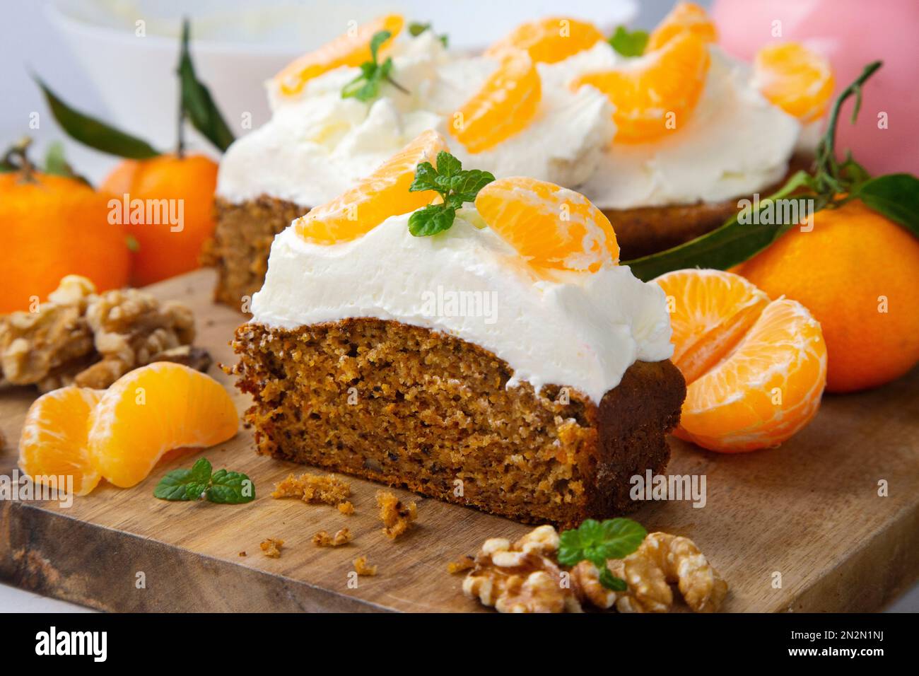 Carrot cake with cream frosting and tangerine pieces Stock Photo - Alamy