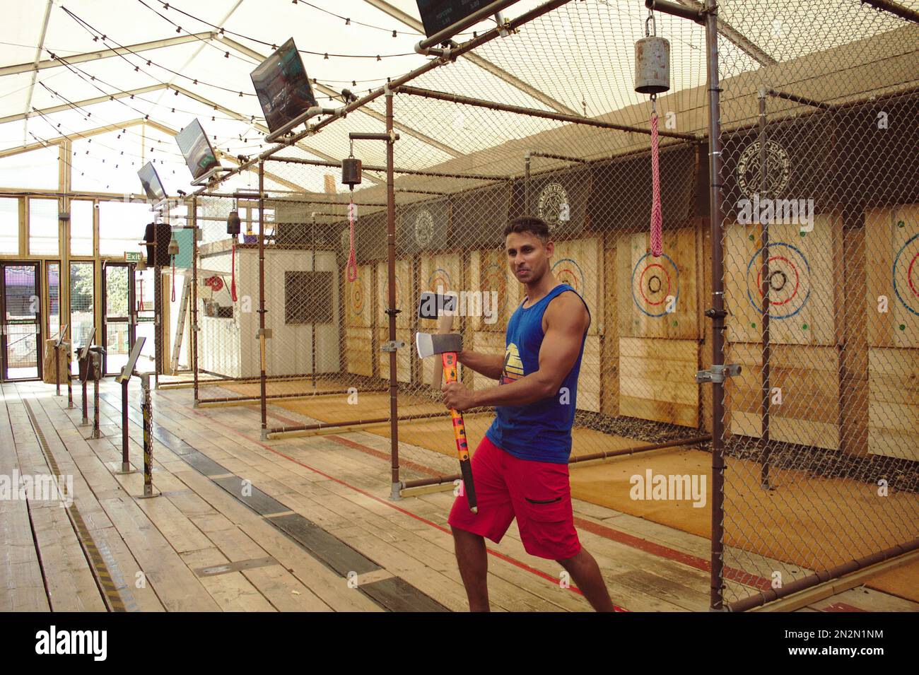 Axe throwing man Stock Photo - Alamy