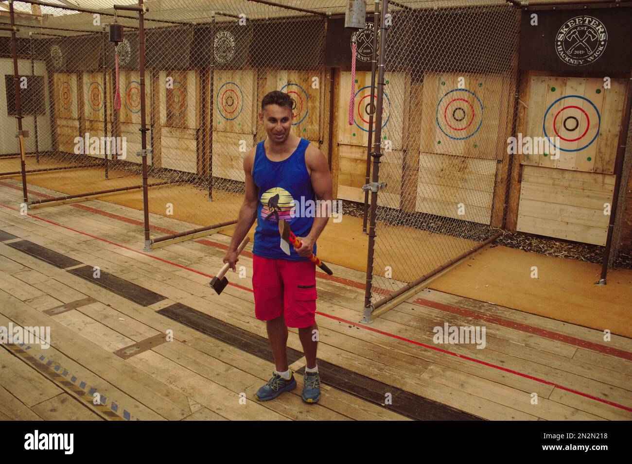 Axe throwing man Stock Photo - Alamy