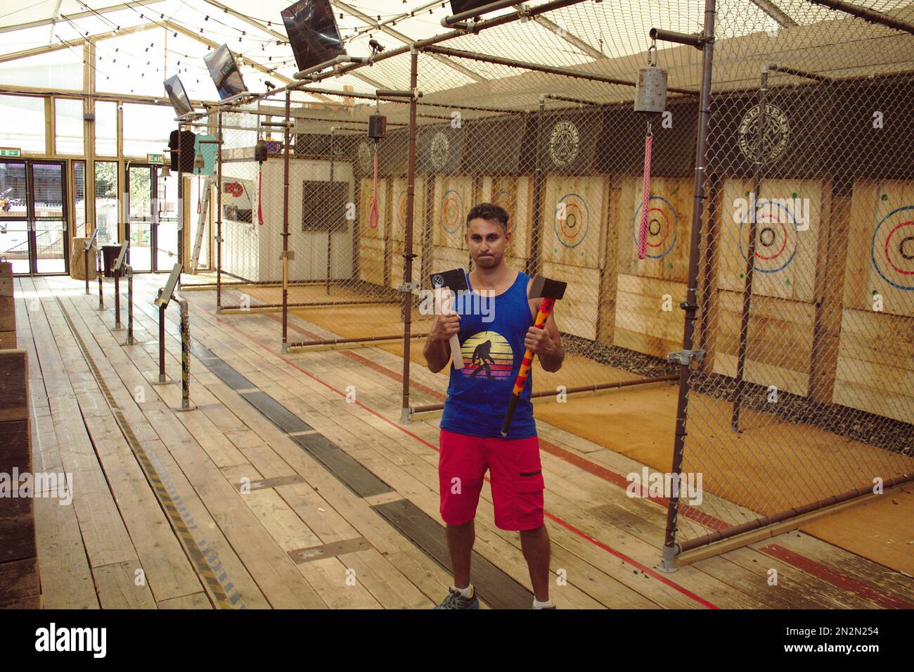 Axe throwing man Stock Photo - Alamy