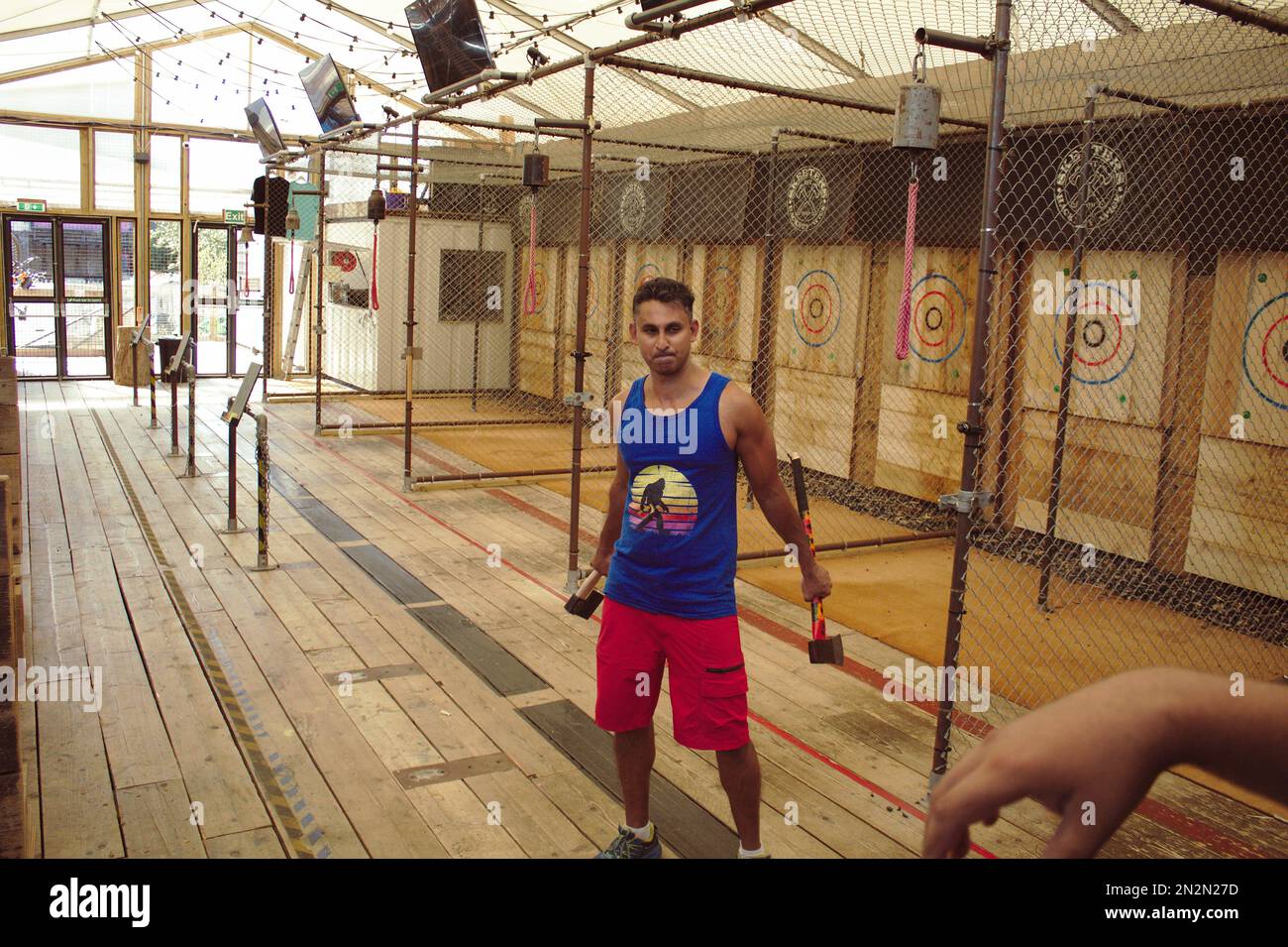 Axe throwing man Stock Photo - Alamy