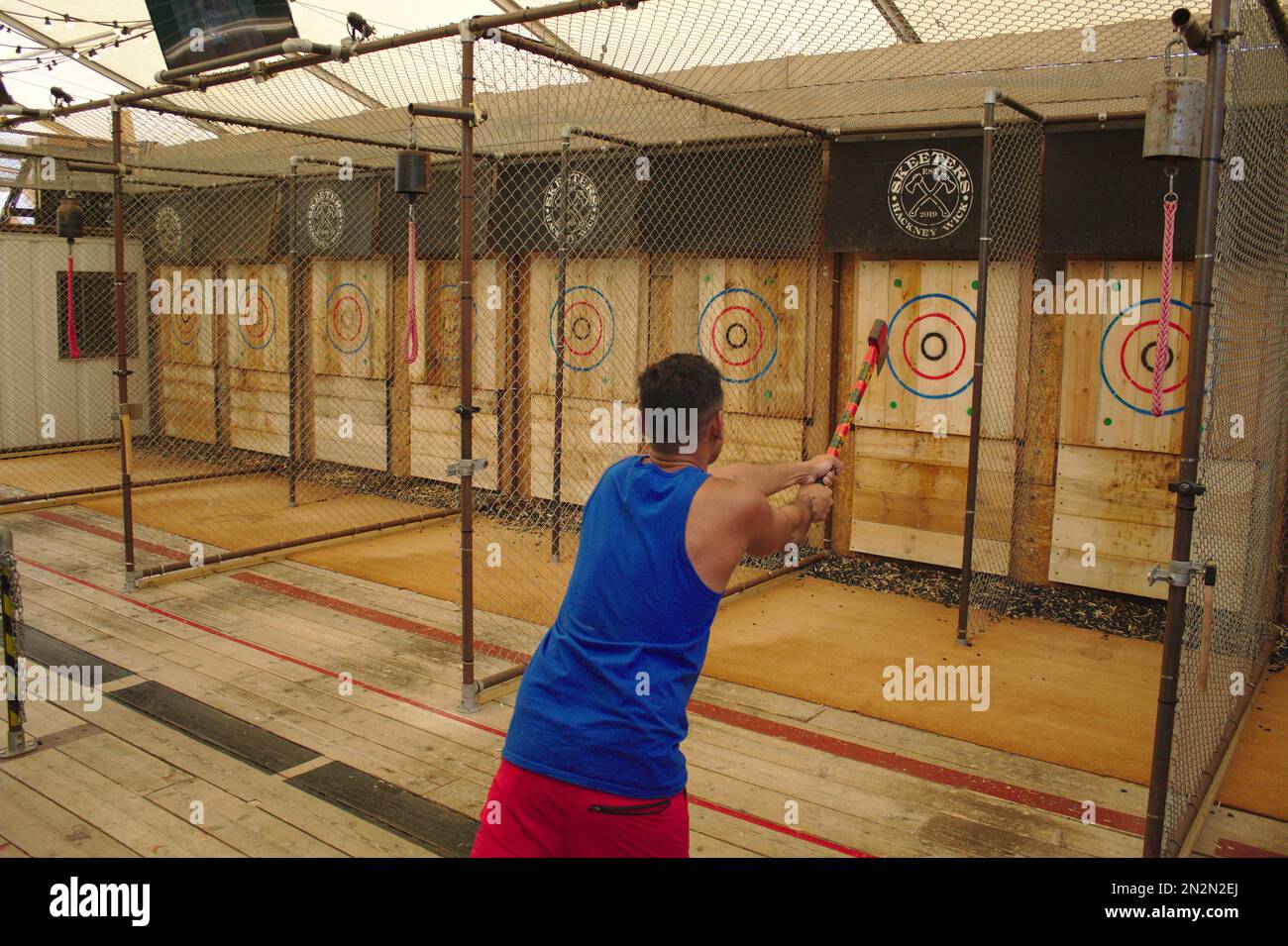 Axe throwing man Stock Photo - Alamy