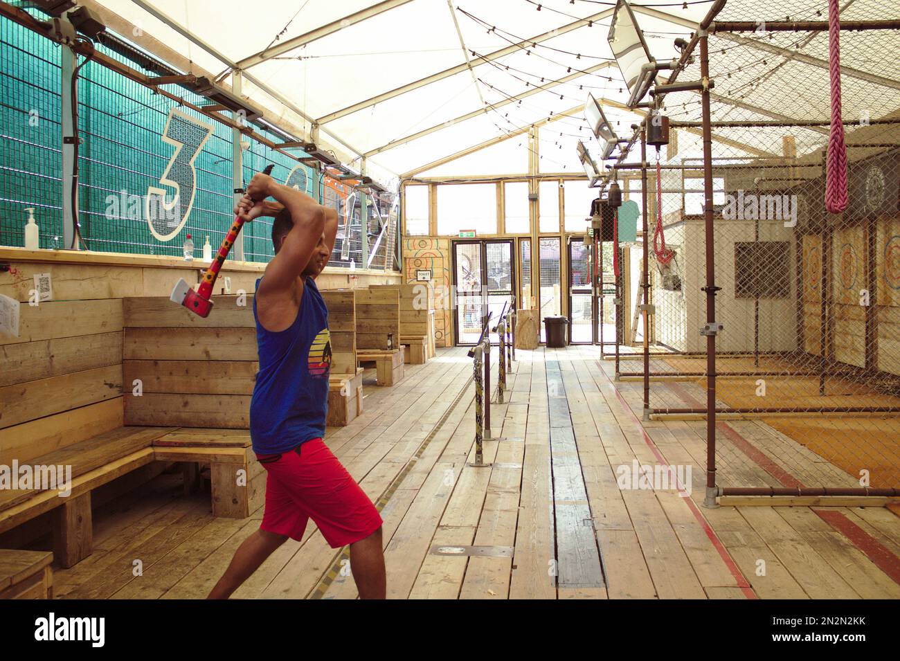 Axe throwing man Stock Photo - Alamy