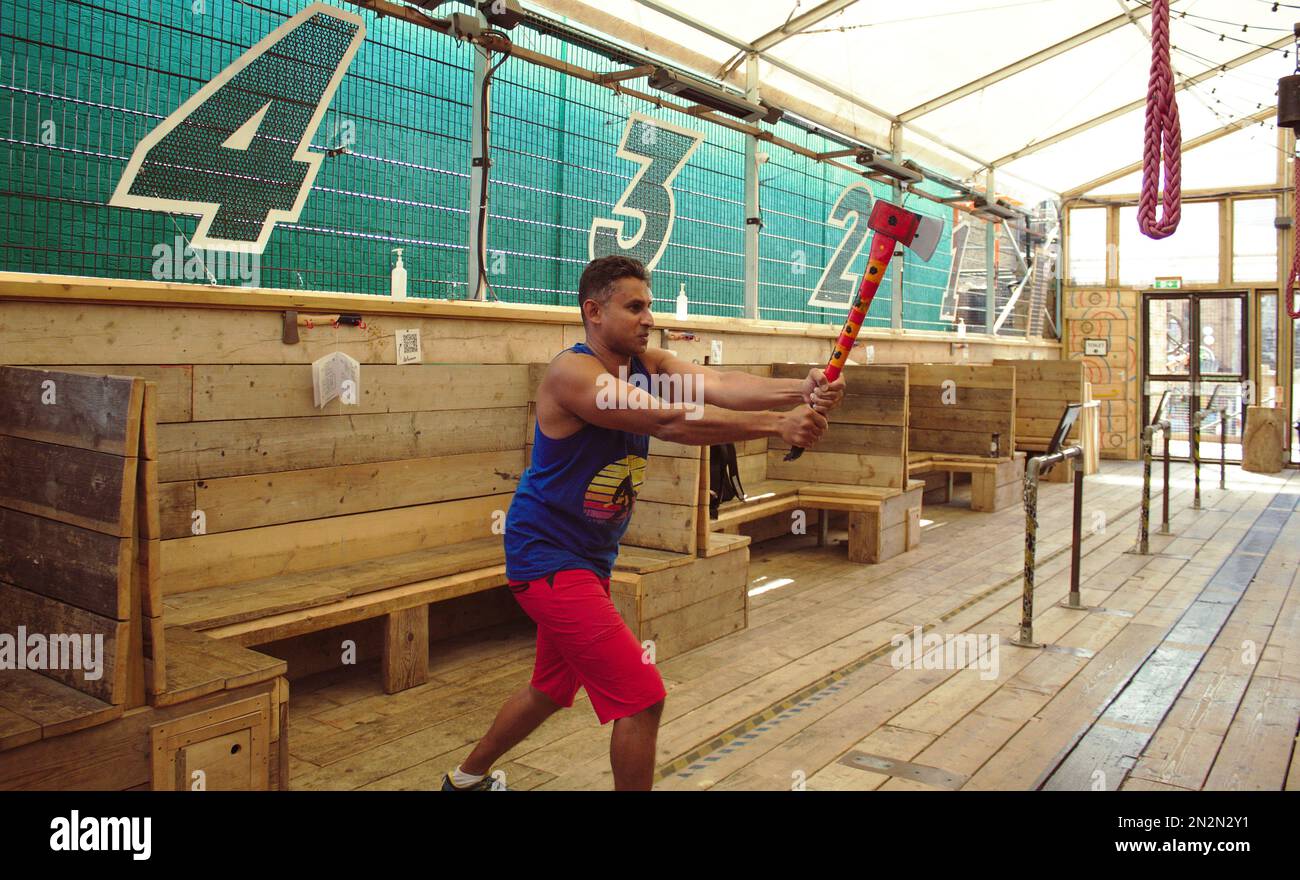 Axe throwing man Stock Photo - Alamy