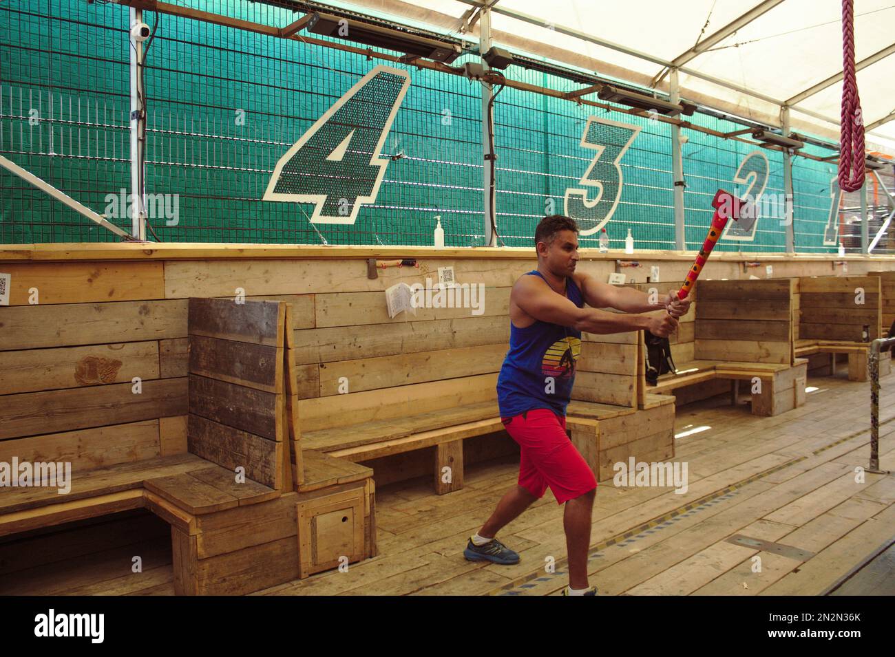 Axe throwing man Stock Photo - Alamy