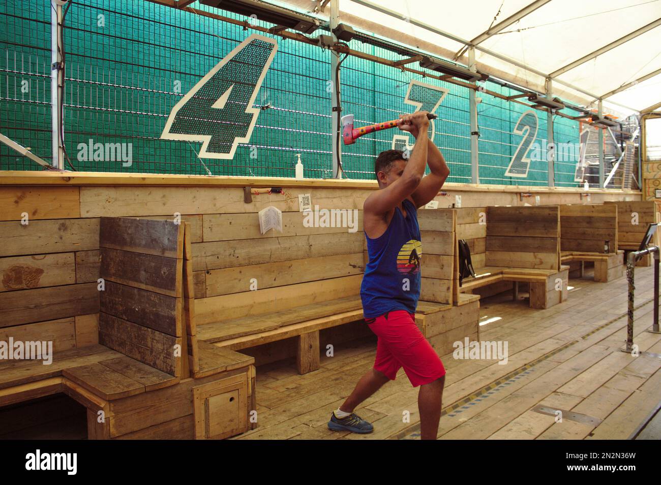 Axe throwing man Stock Photo - Alamy