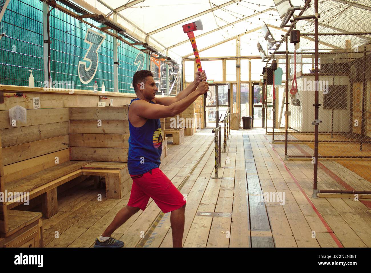 Axe throwing man Stock Photo - Alamy