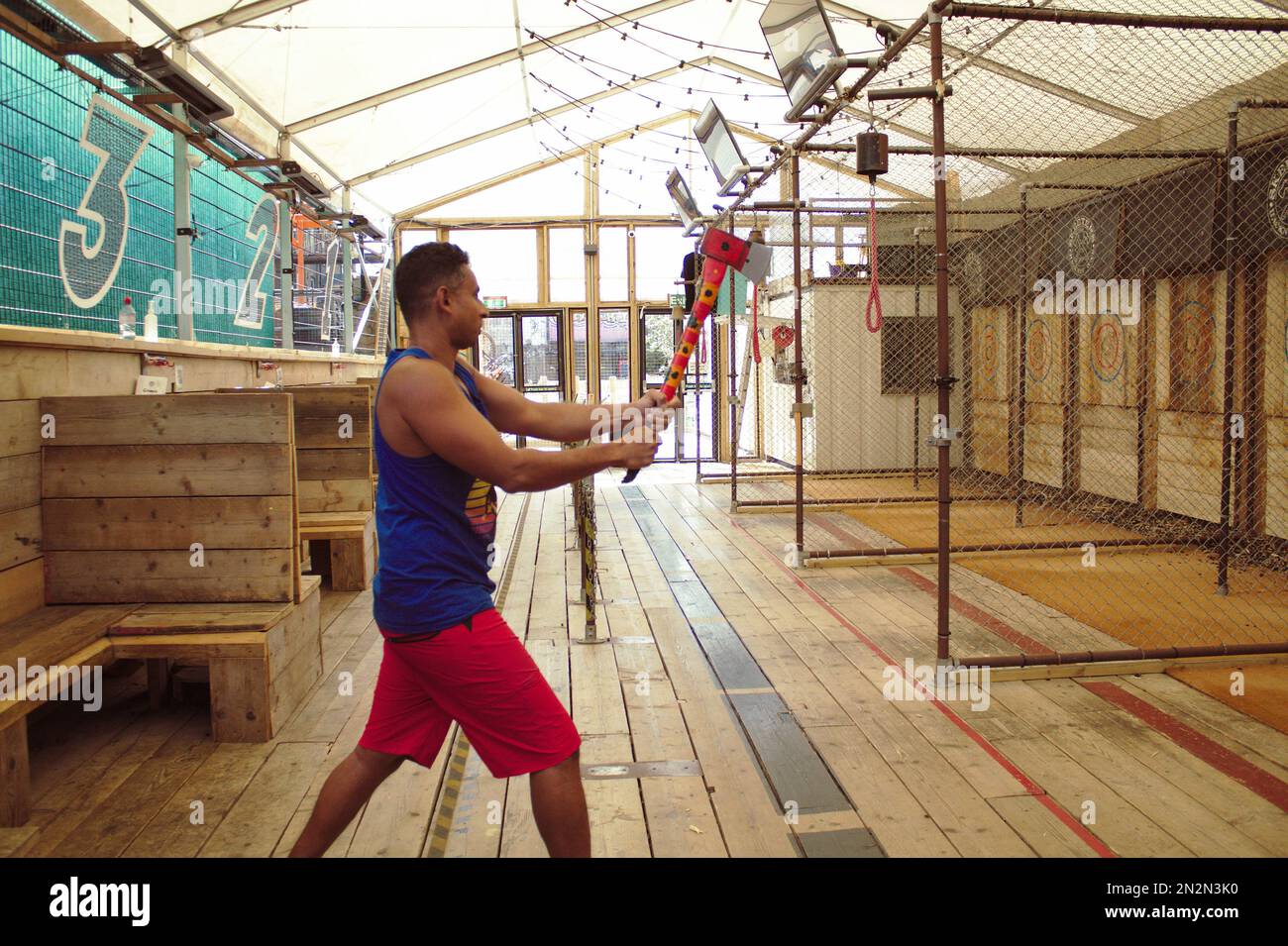 Axe throwing man Stock Photo - Alamy