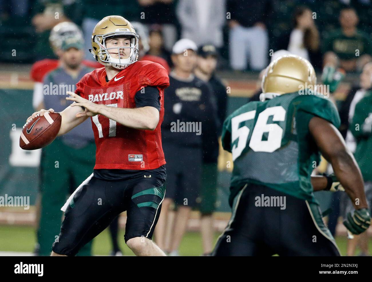 Baylor quarterback Seth Russell (17) passes under pressure from K.J ...