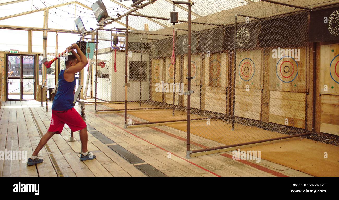 Axe throwing man Stock Photo - Alamy