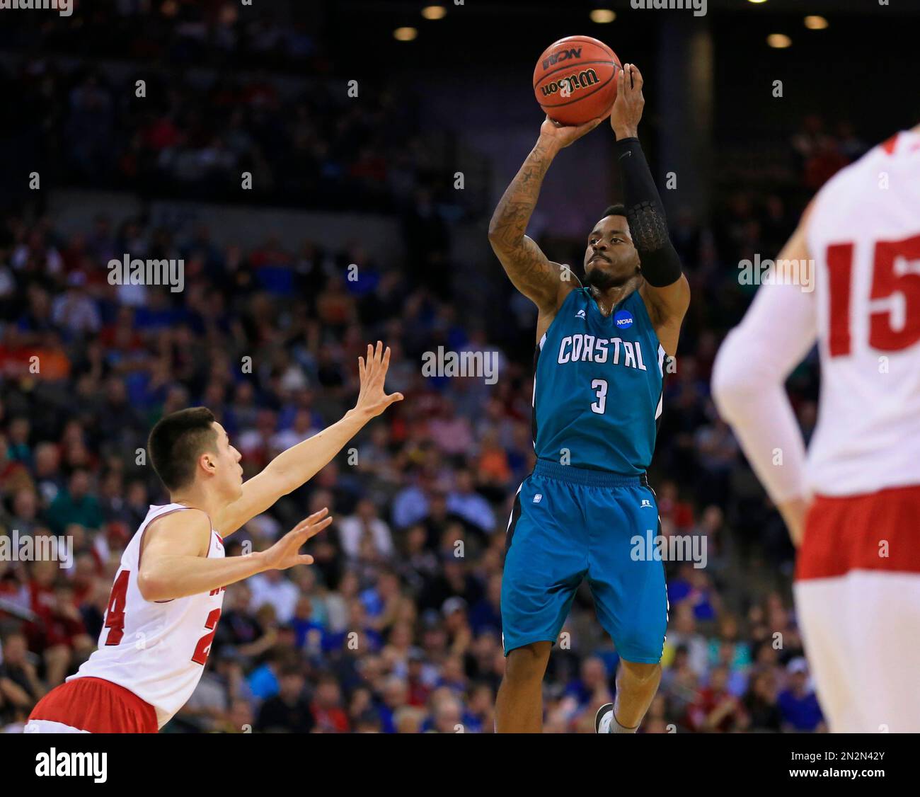 Coastal Carolina's Josh Cameron (3) shoots over Wisconsin's Bronson ...