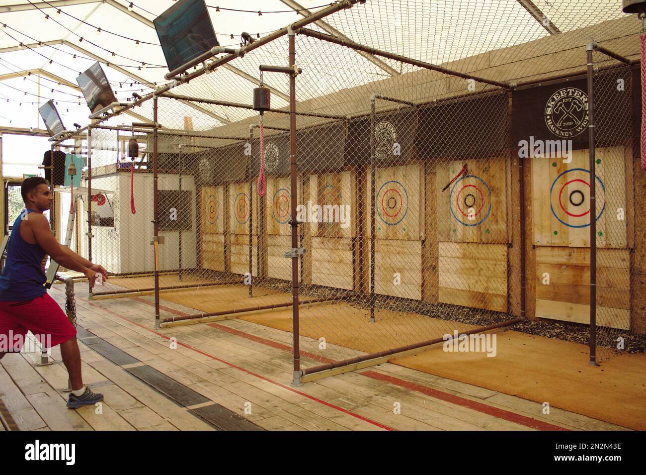 Axe throwing man Stock Photo - Alamy