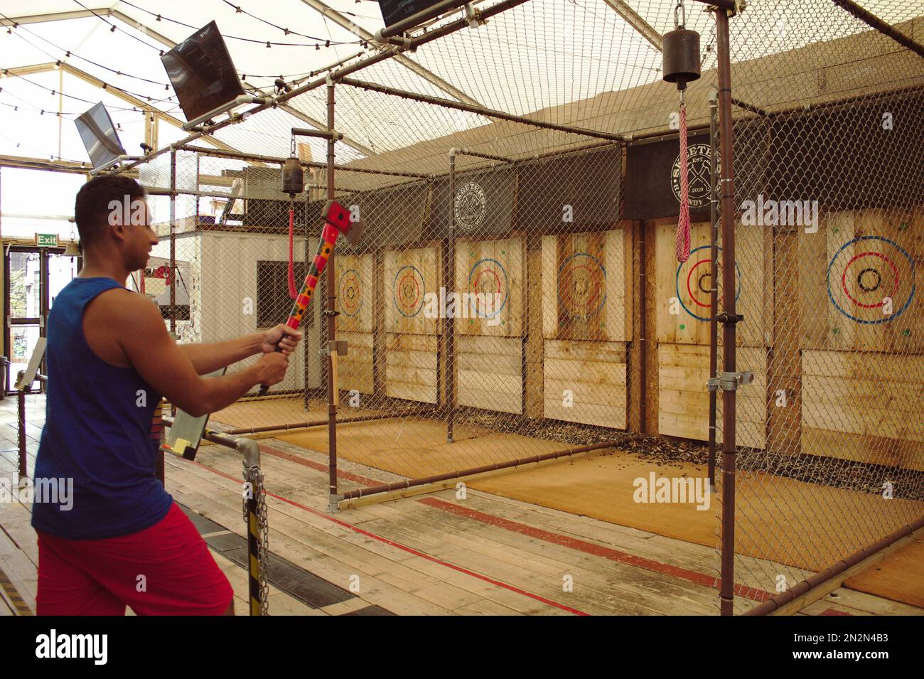 Axe throwing man Stock Photo - Alamy
