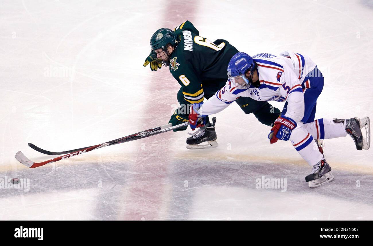 Lowell forward Joe Gambardella (5) tries to knock the puck away from ...