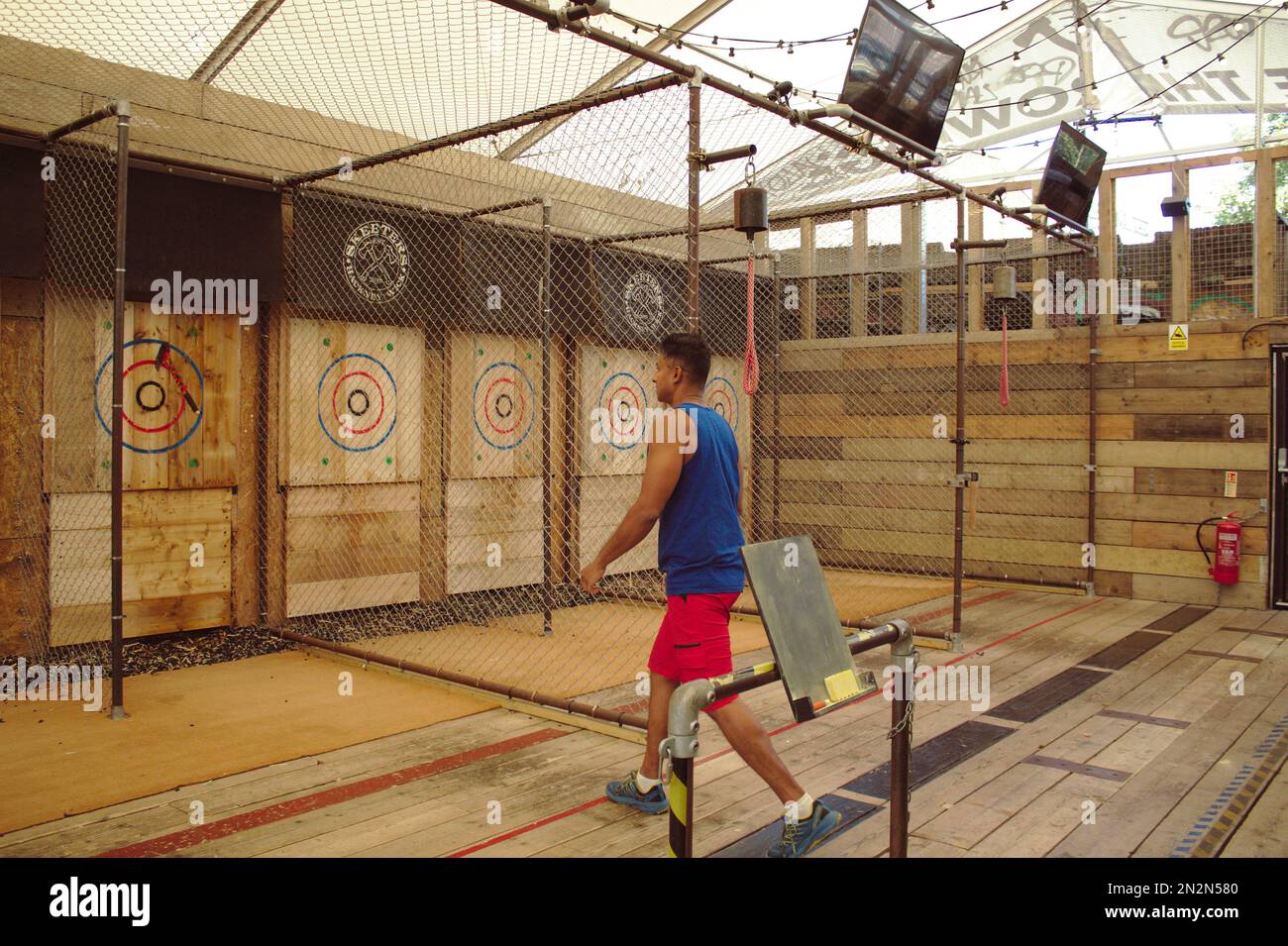 Axe throwing man Stock Photo - Alamy