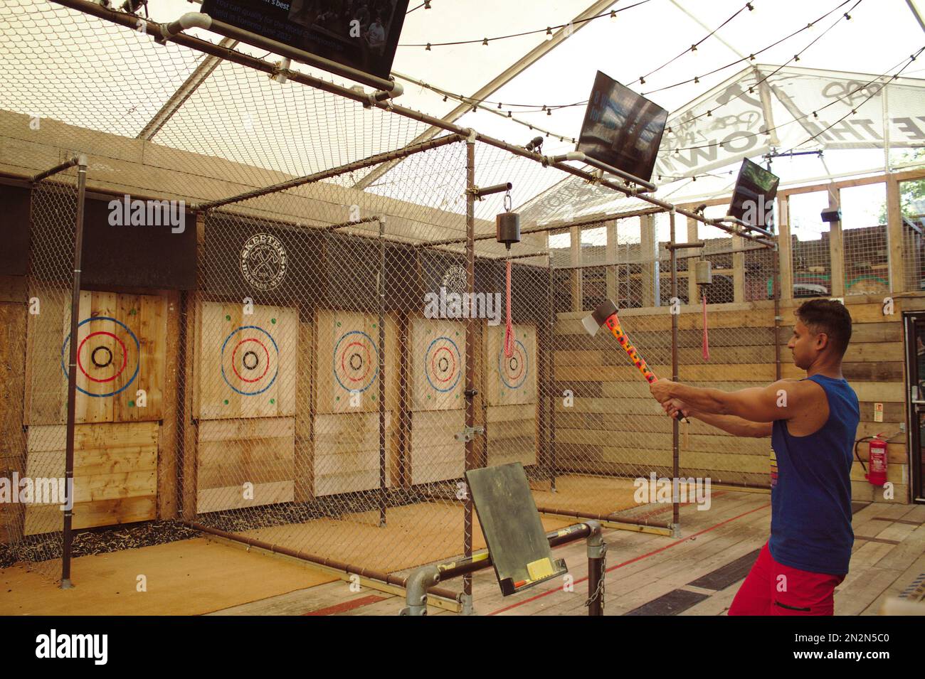 Axe throwing man Stock Photo - Alamy