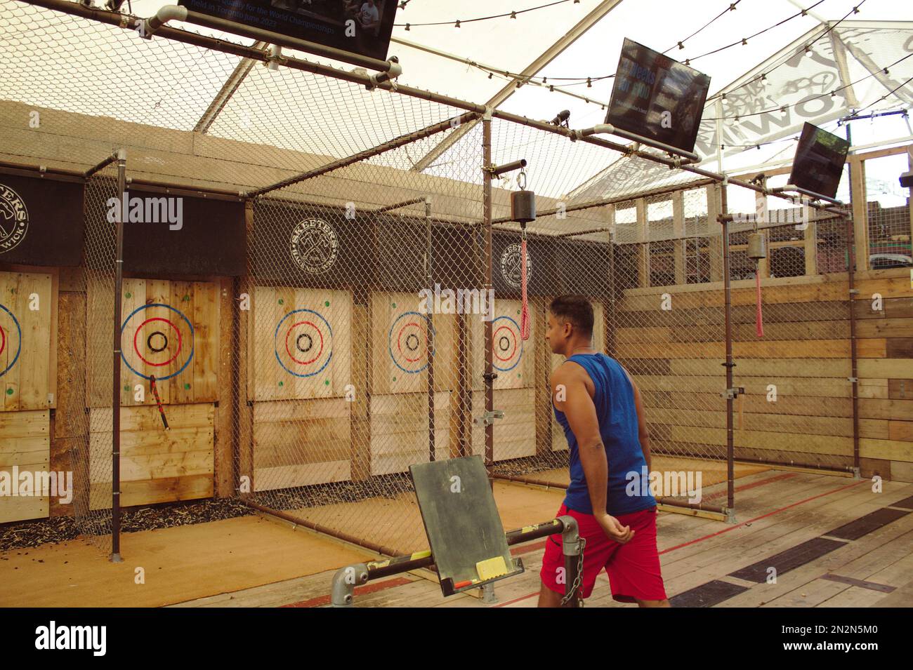 Axe throwing man Stock Photo - Alamy