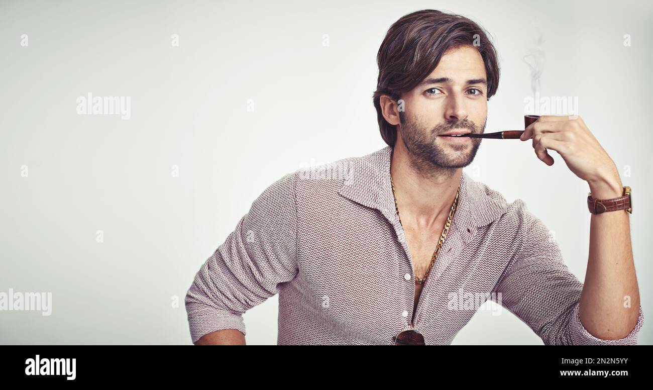 Groovy cool. A young man with 70s style sitting in the studio and ...