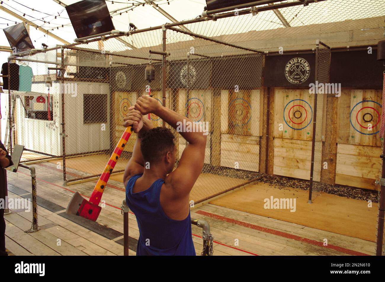 Axe throwing man Stock Photo - Alamy
