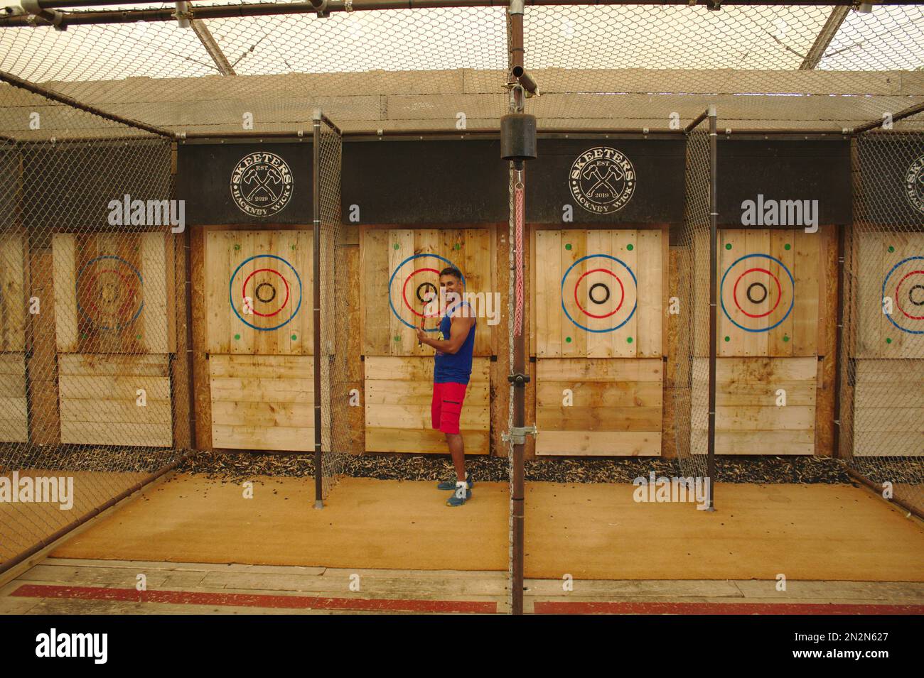 Axe throwing man Stock Photo - Alamy