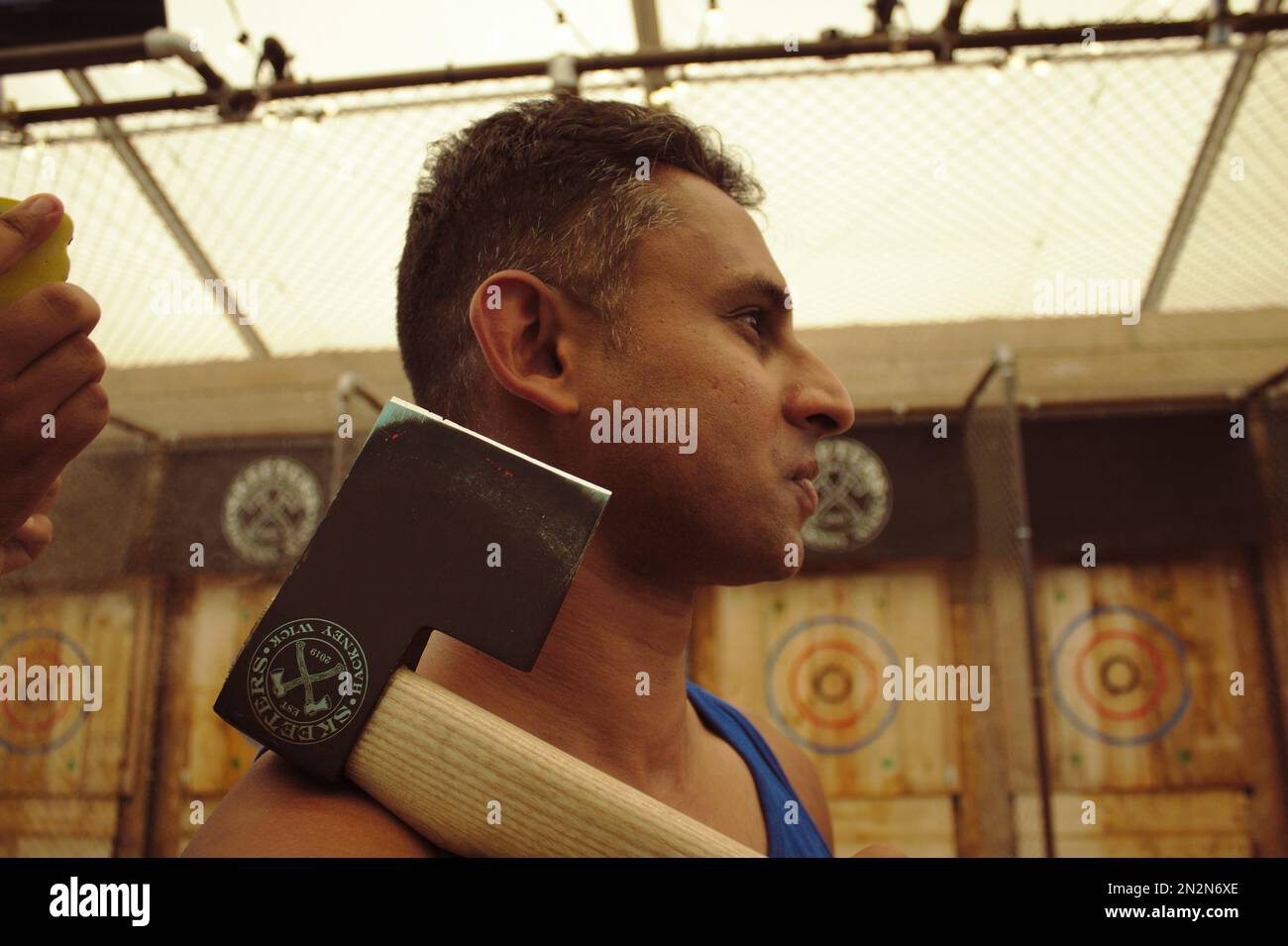 Axe throwing man Stock Photo - Alamy