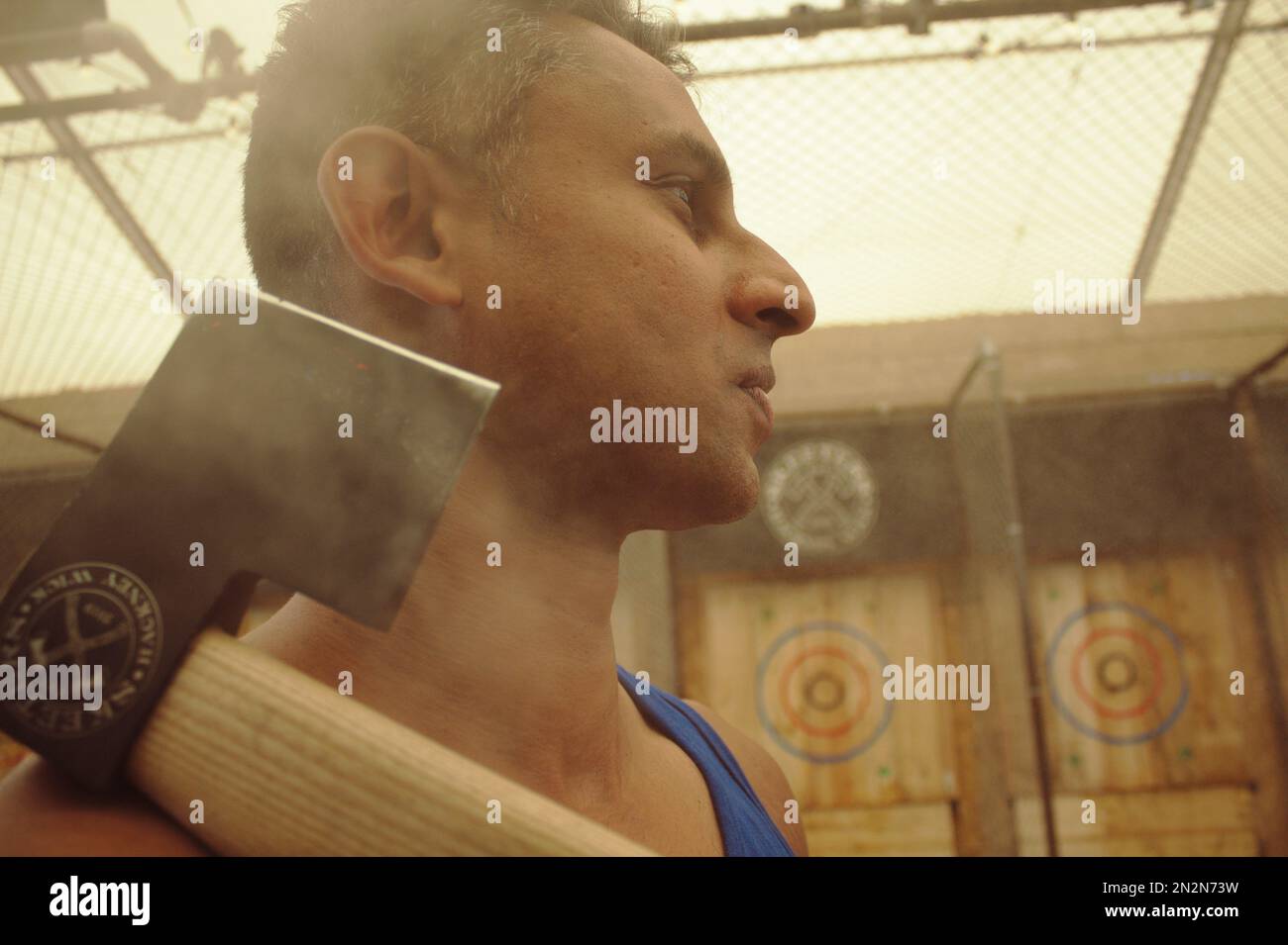 Axe throwing man Stock Photo - Alamy