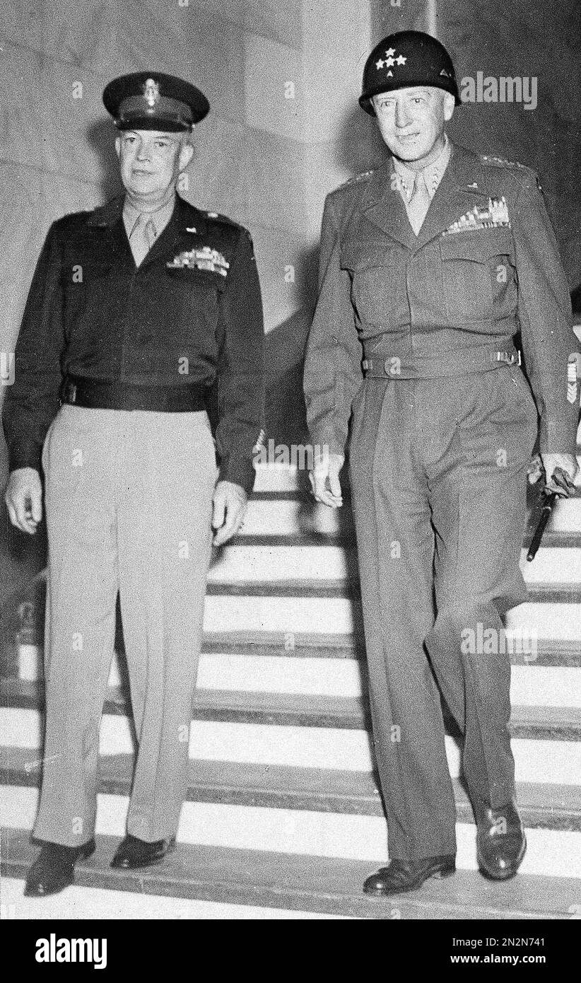 General George S. Patton, right, walks down stairs at Army headquarters ...