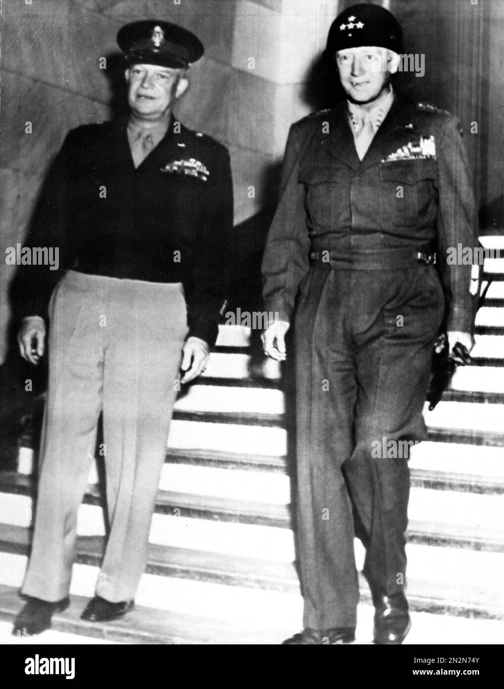 General George S. Patton, right, walks down stairs at Army headquarters ...