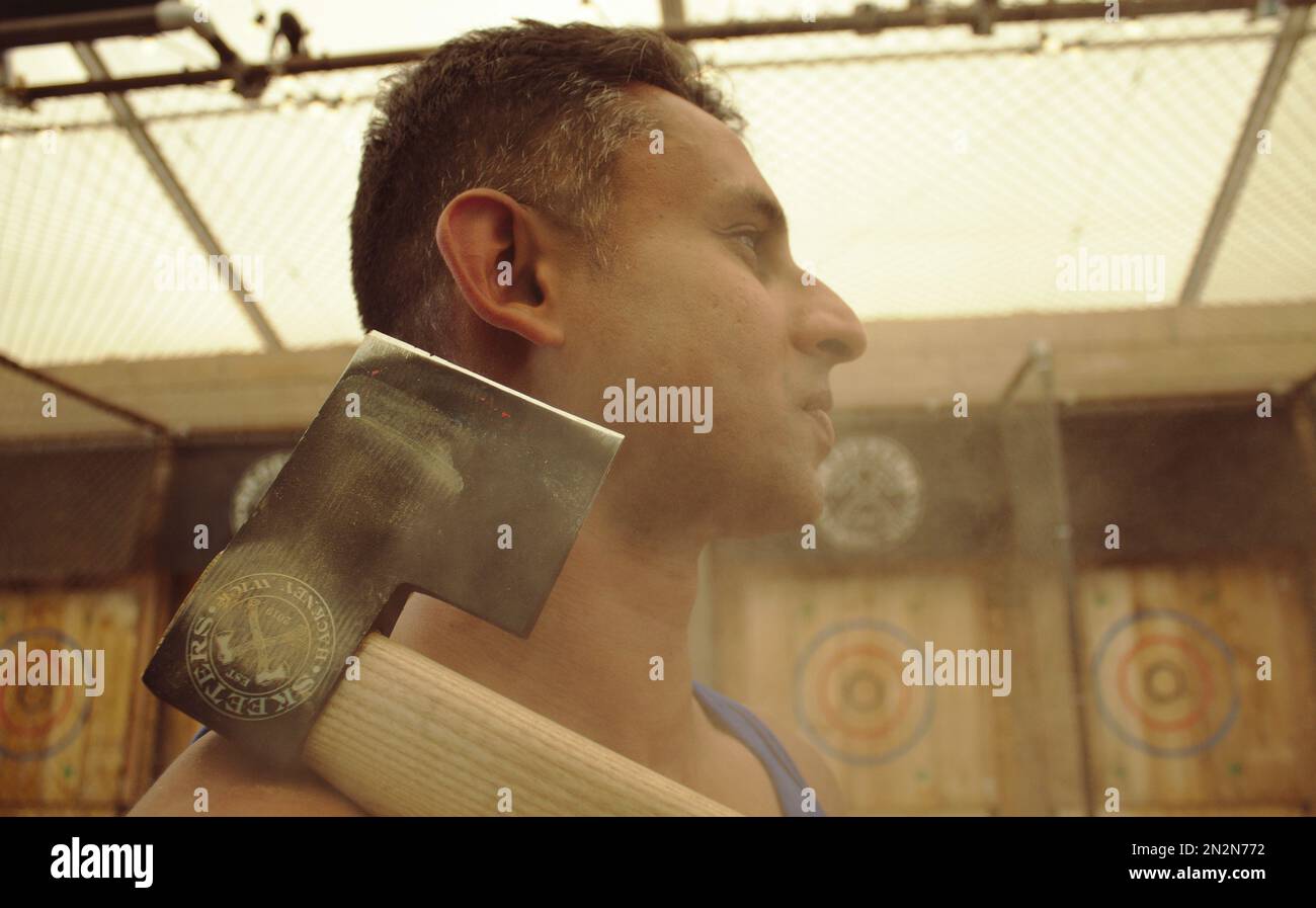 Axe throwing man Stock Photo - Alamy