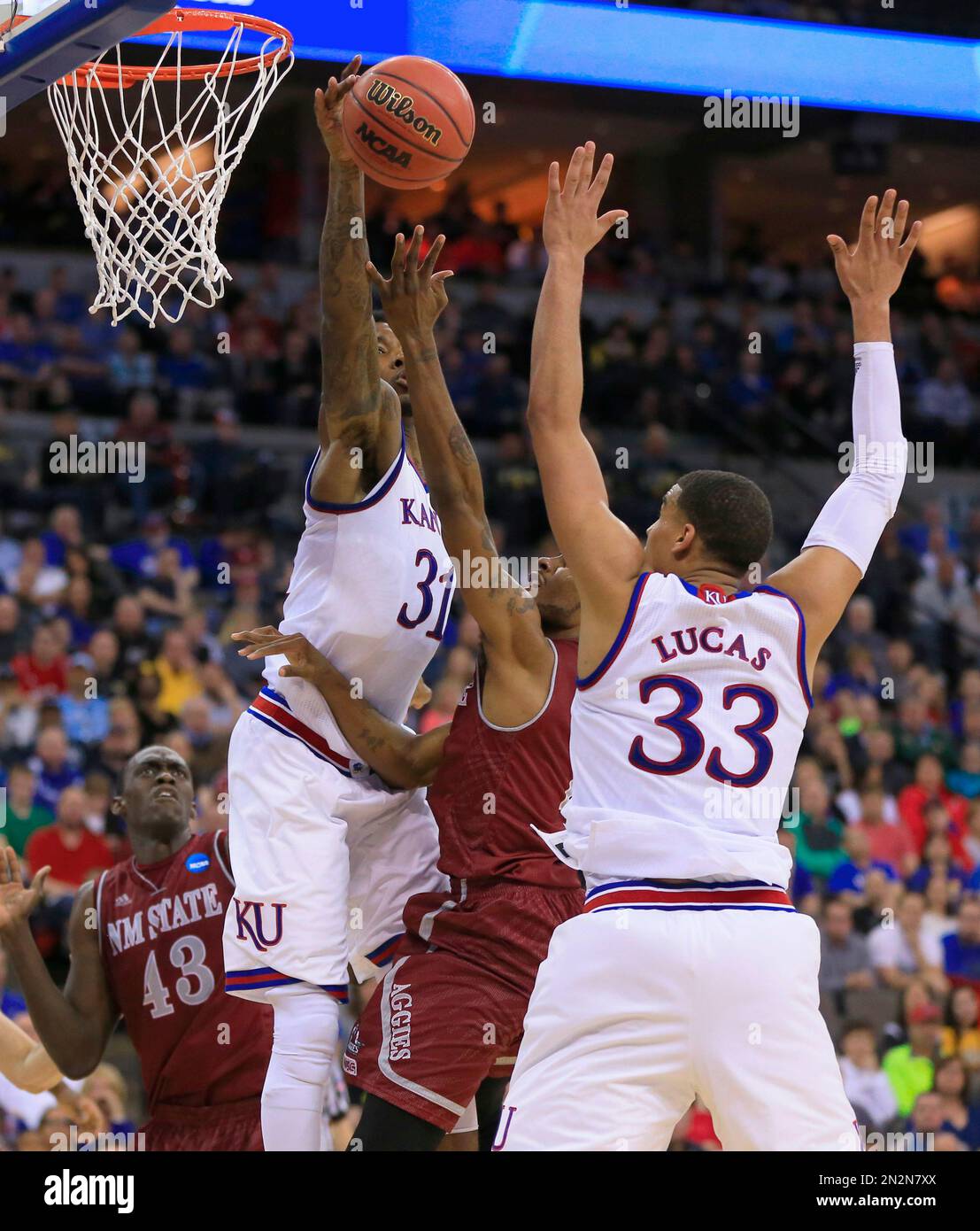 Kansas' Jamari Traylor (31) blocks a shot by by New Mexico State's Ian ...