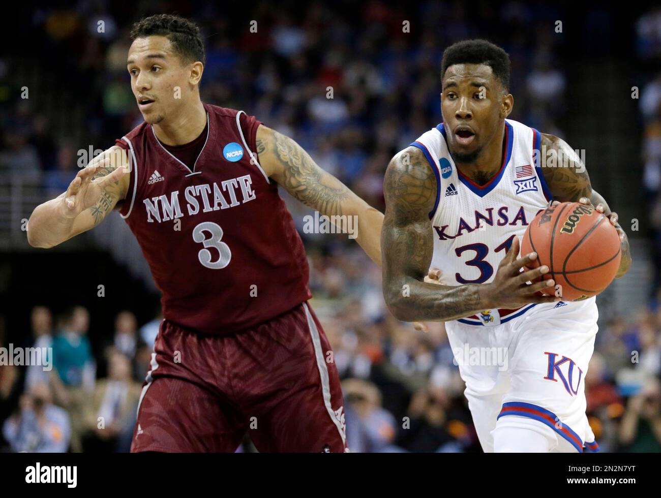 Kansas forward Jamari Traylor drives up court past New Mexico State ...