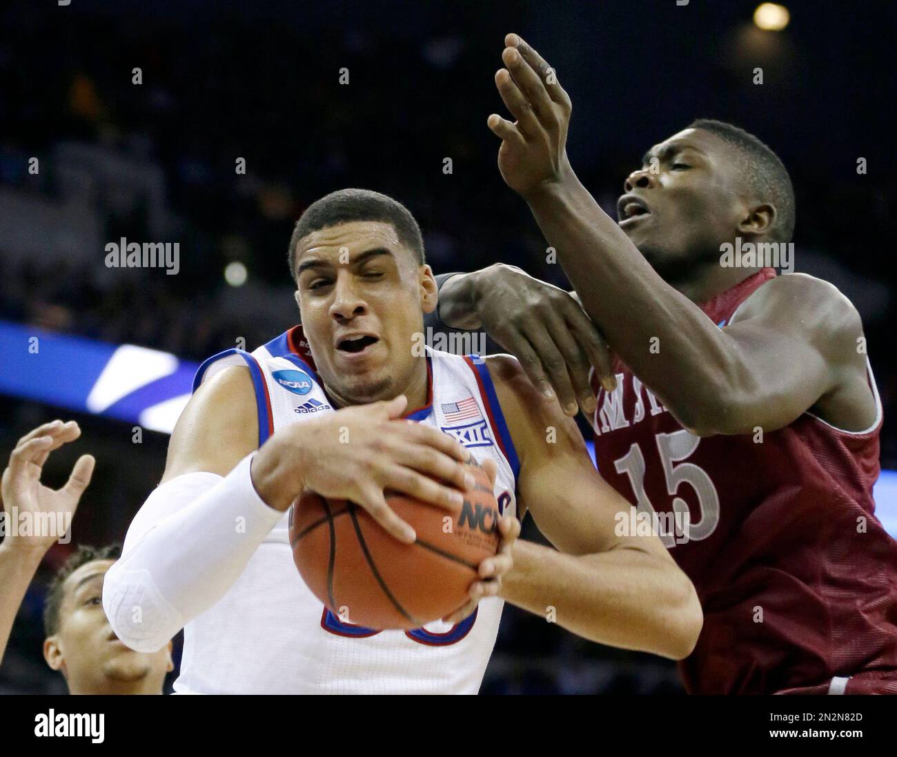 Kansas forward Landen Lucas, left, fights for a rebound with New Mexico ...