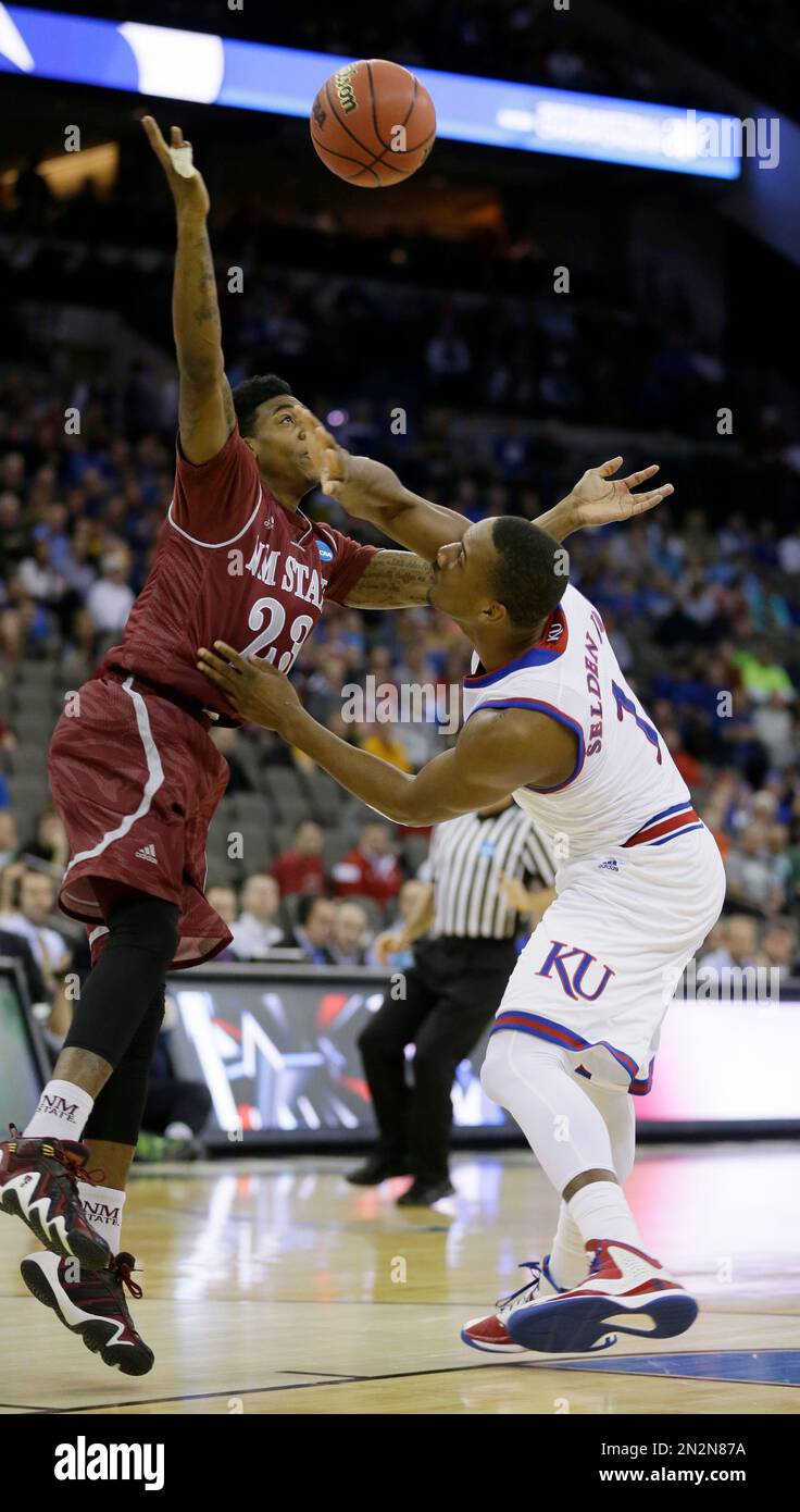 New Mexico State guard Daniel Mullings, left, fights for a loose ball ...