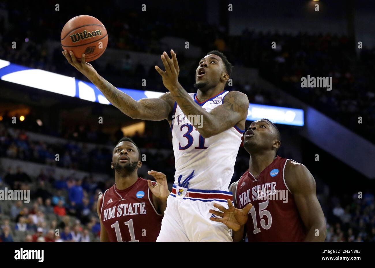 Kansas forward Jamari Traylor (31) drives to the basket past New Mexico ...