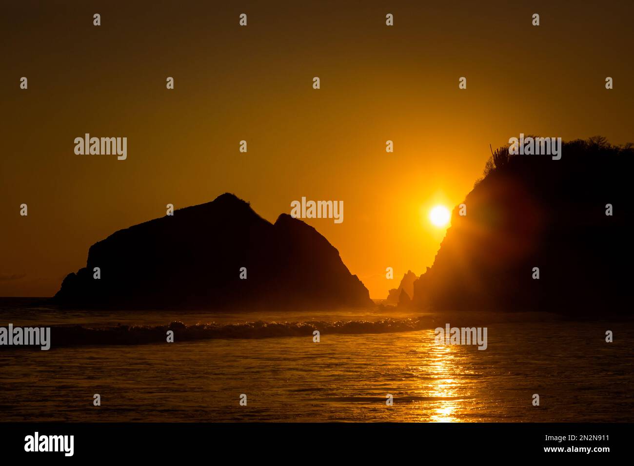 Beautiful sunset behind rocks on Zipolite beach in Mexico. Landscape ...