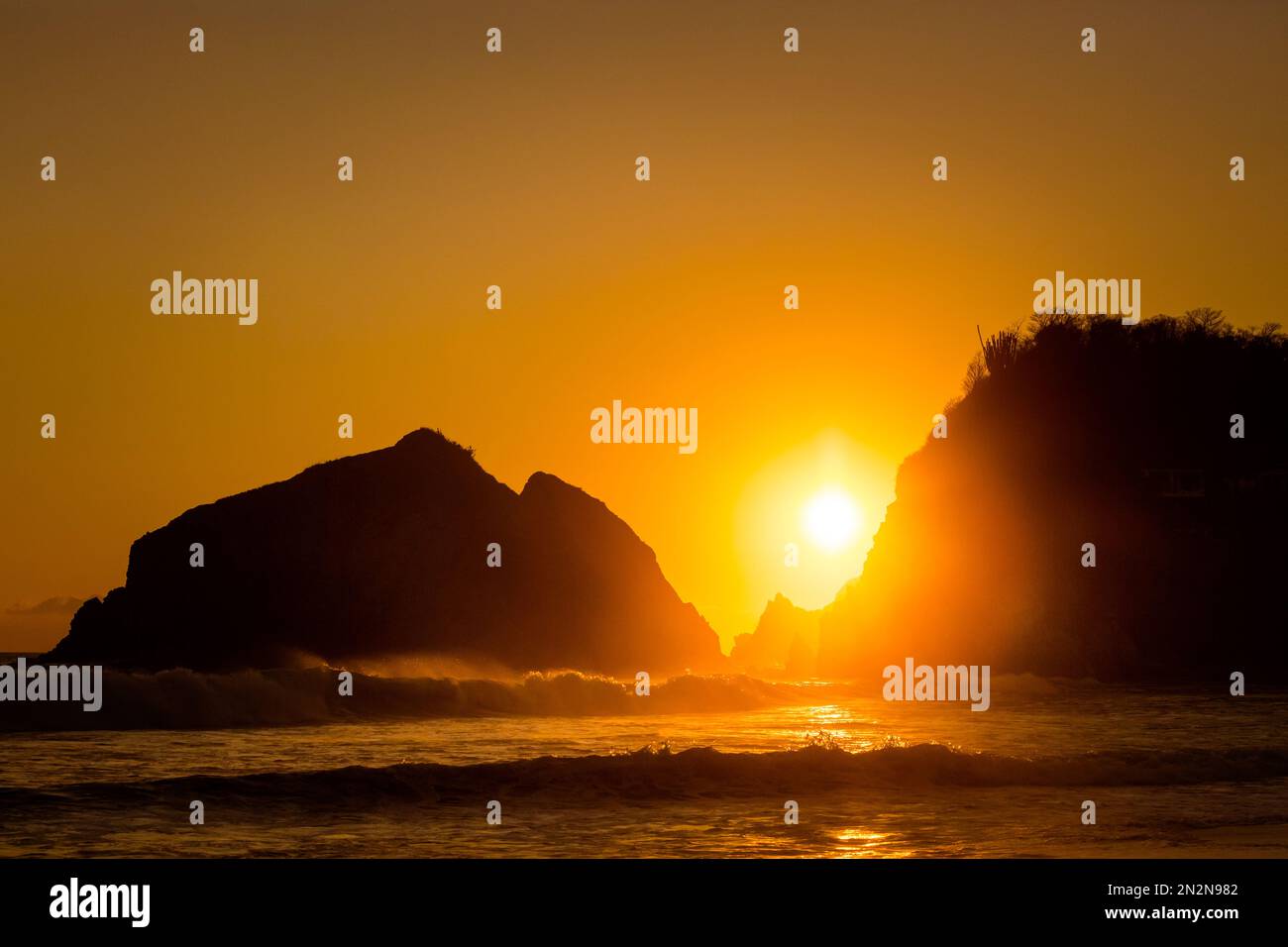 Beautiful sunset behind rocks on Zipolite beach in Mexico. Landscape ...