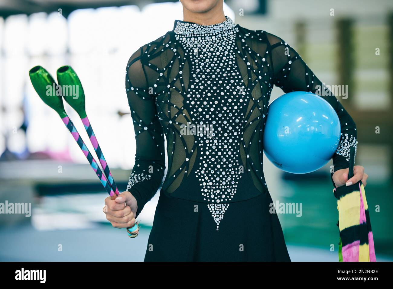 Rhythmic gymnast, dancer and gymnastic equipment in a gym for a ...
