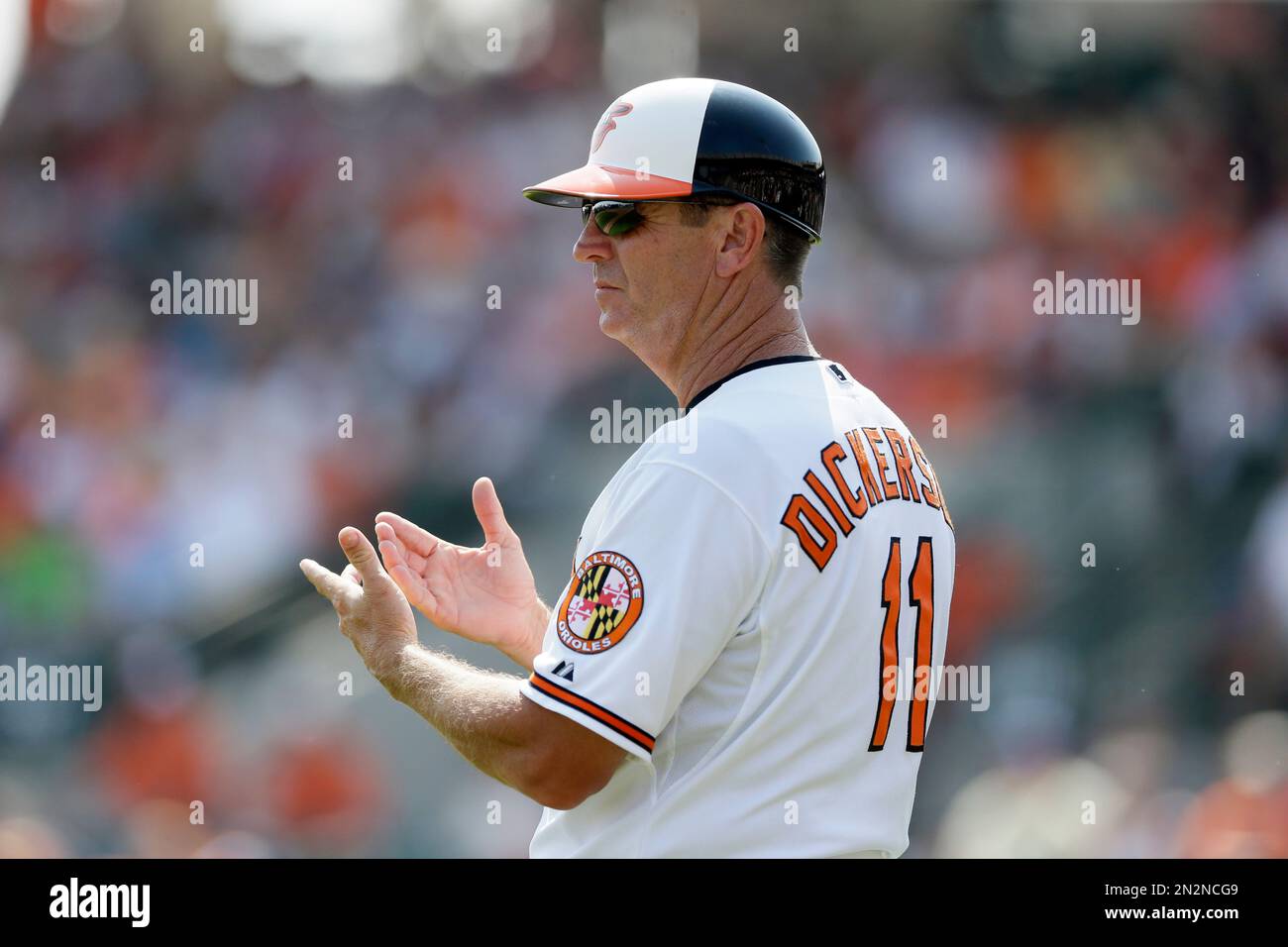 Baltimore Orioles third base coach Bobby Dickerson signals during a ...