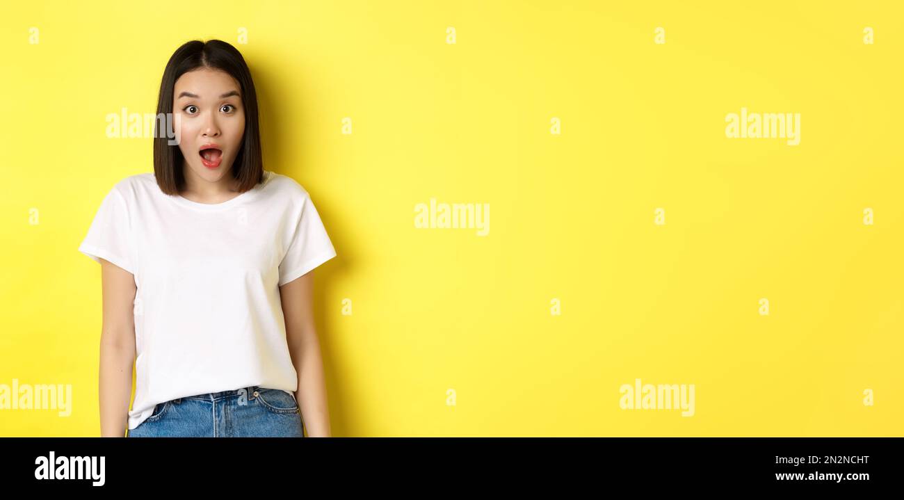 Beauty and fashion concept. Surprised asian girl open mouth and staring ...