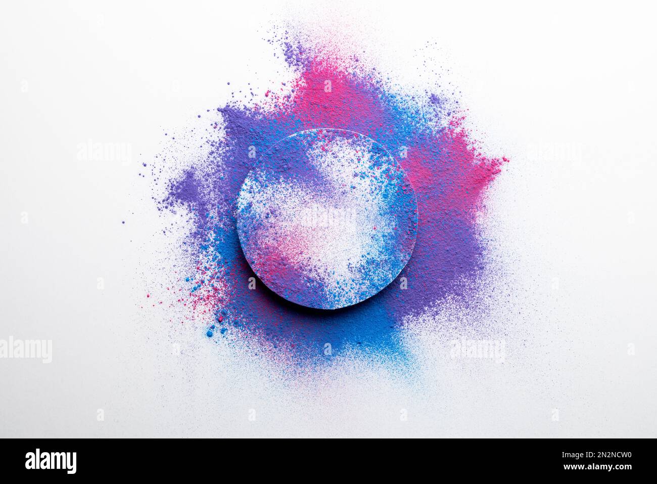 Close up of multi coloured powder with white circle and copy space on ...