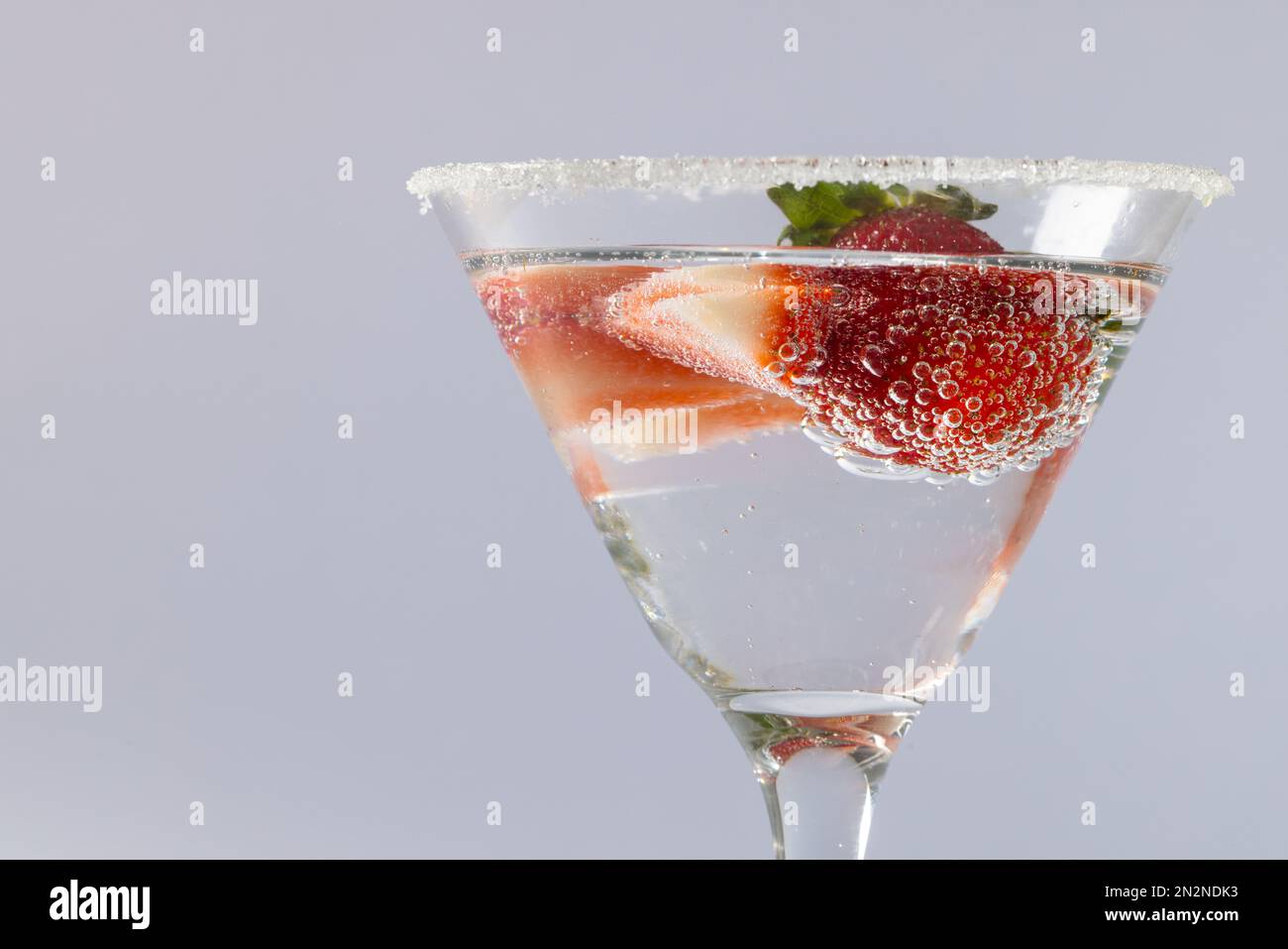 Glass with drink and fruits over grey background Stock Photo - Alamy