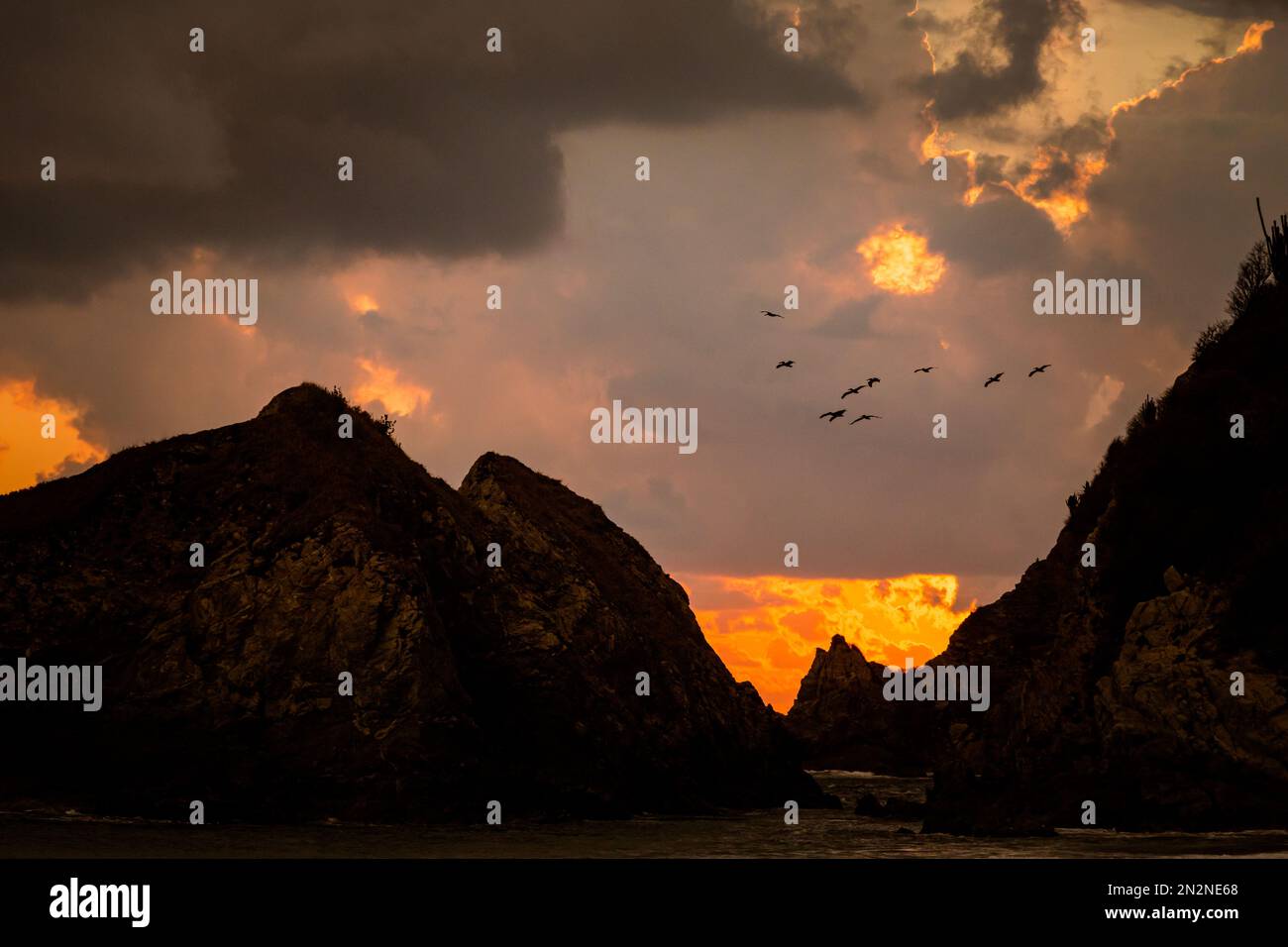 Beautiful sunset behind rocks on Zipolite beach in Mexico. Landscape ...