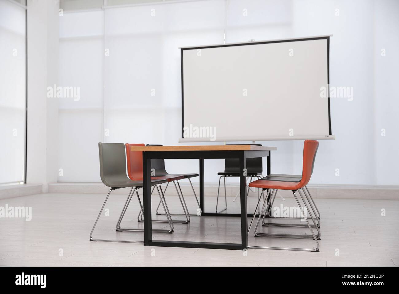 Conference room interior with wooden table and video projection screen ...