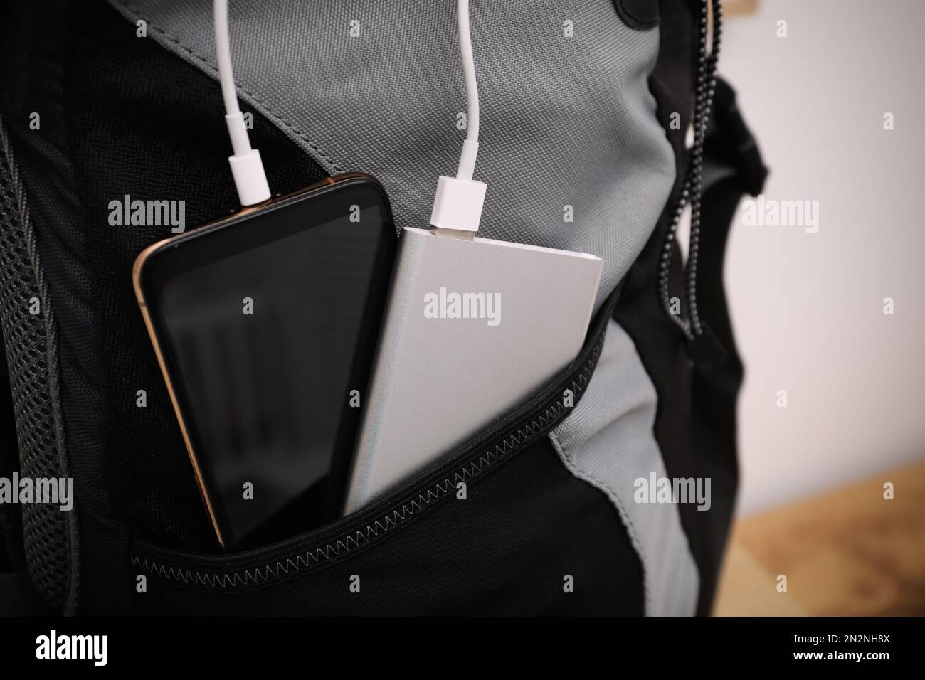 Smartphone charging with power bank in backpack, closeup Stock Photo ...