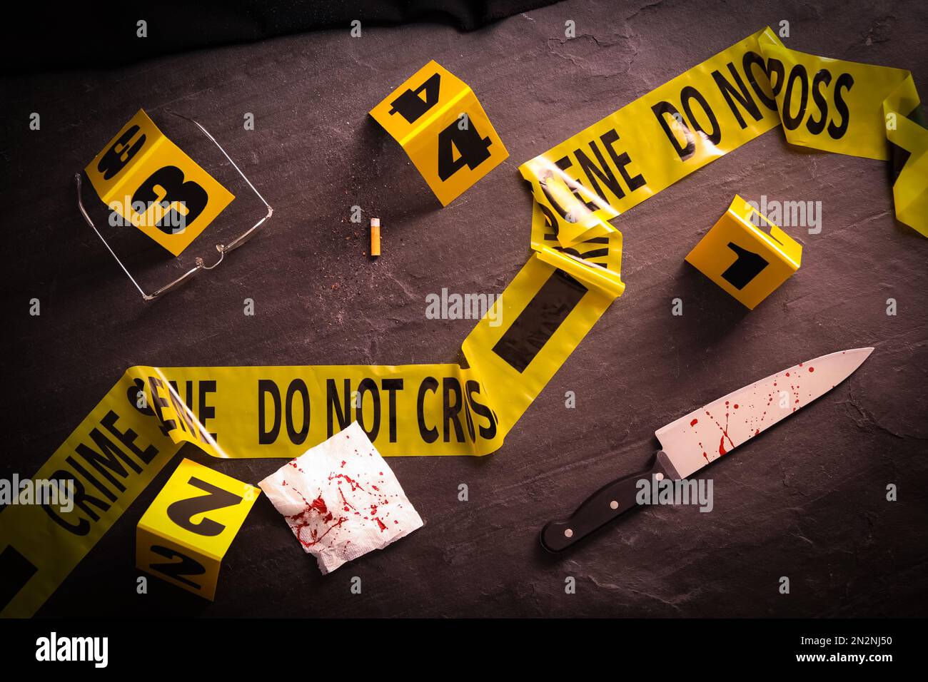 Flat lay composition with evidences and crime scene markers on black ...