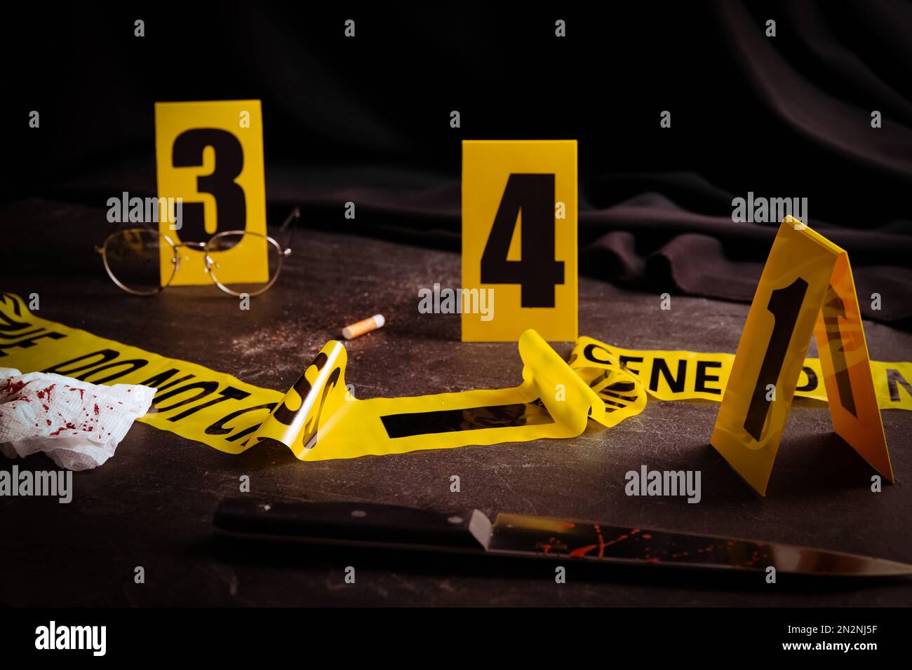 Bloody knife, tape and markers on black slate table. Crime scene Stock ...